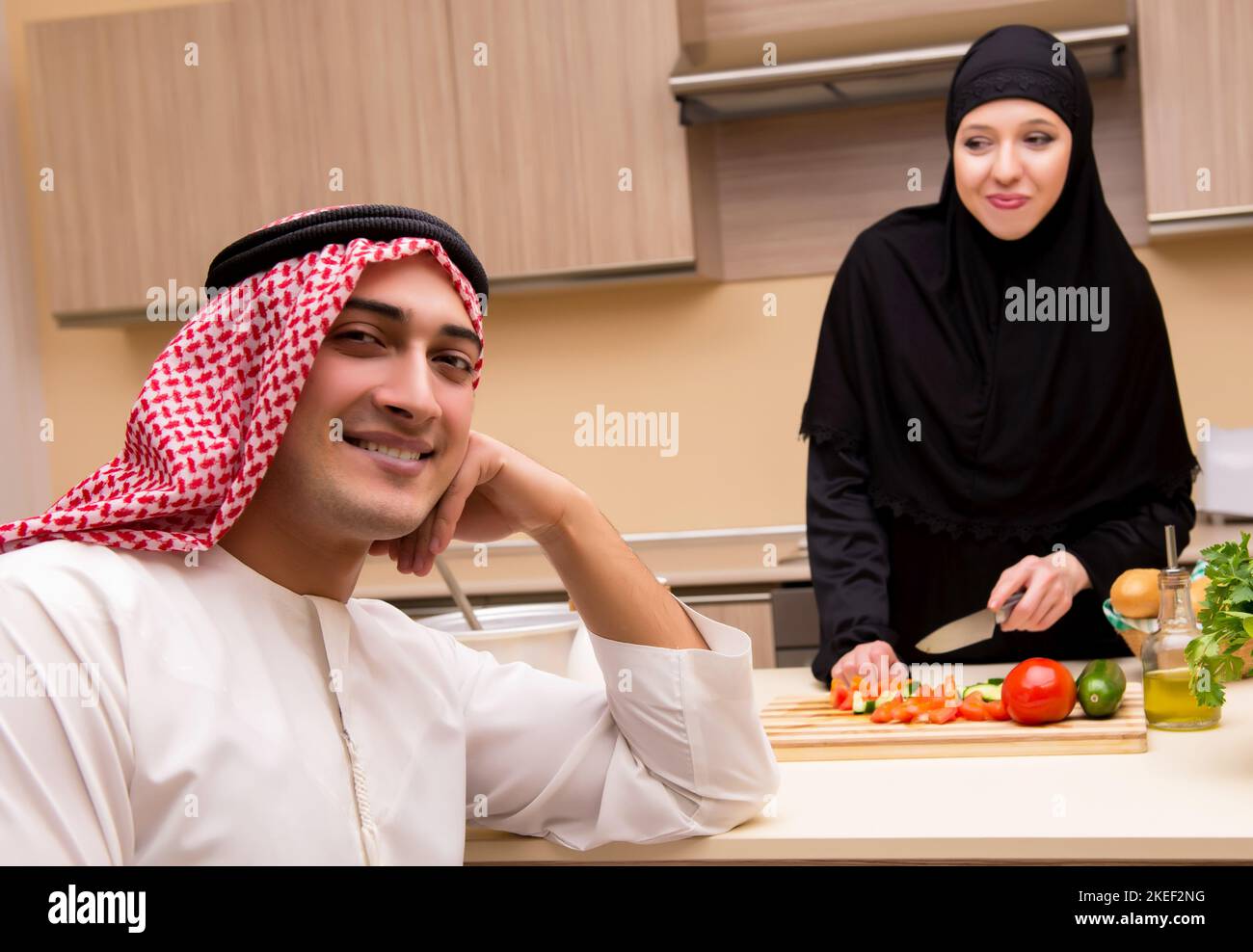 The young arab family in the kitchen Stock Photo - Alamy