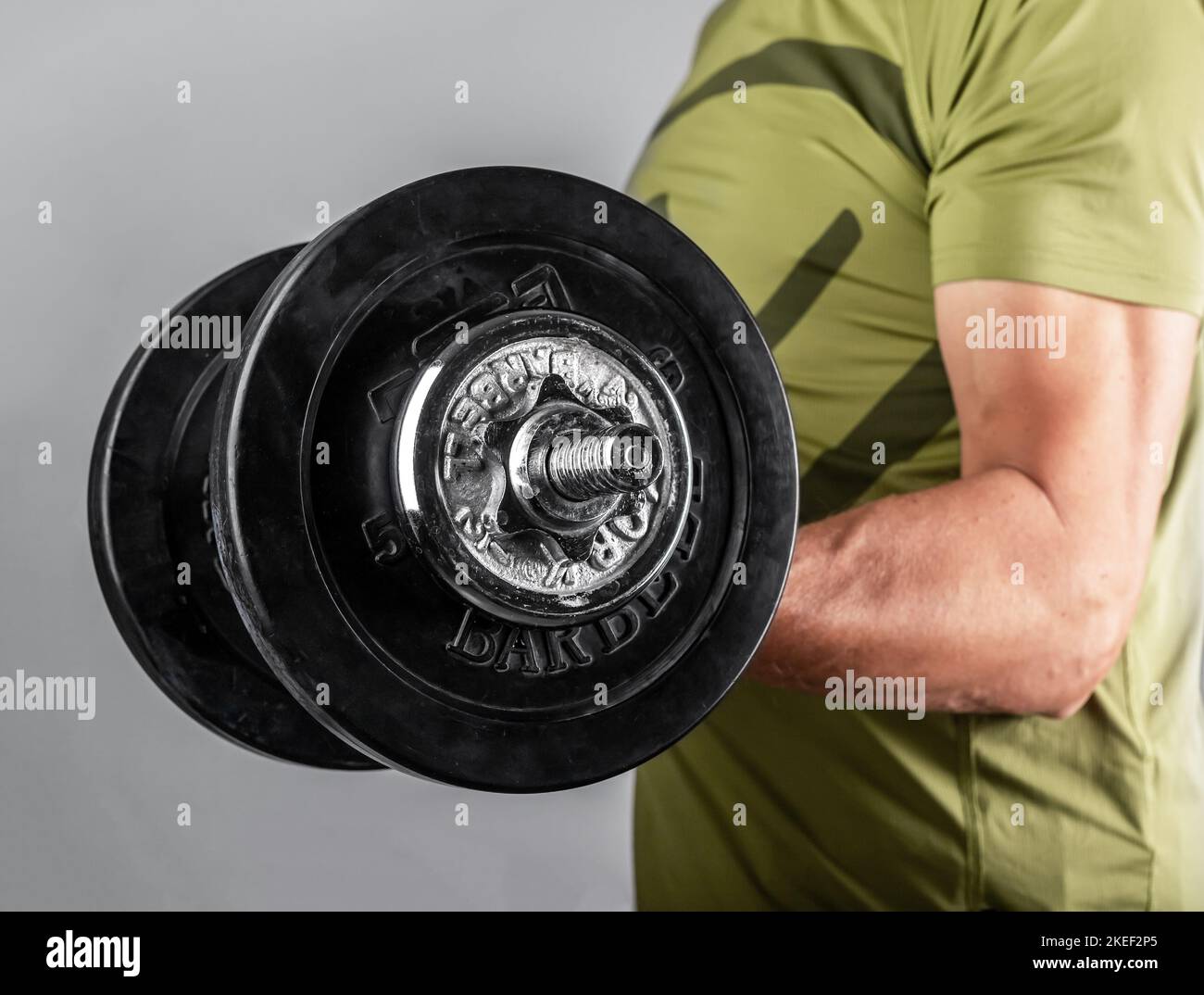 Hand lifting heavy dumbbell. Bodybuilder training biceps closeup. High ...