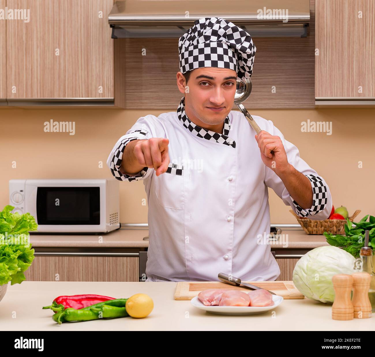 The young chef working in the kitchen Stock Photo - Alamy