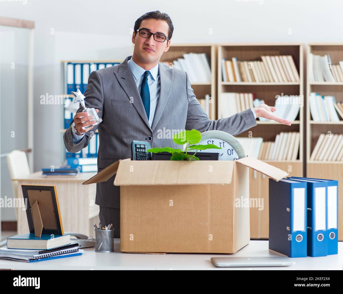 The man moving office with box and his belongings Stock Photo - Alamy