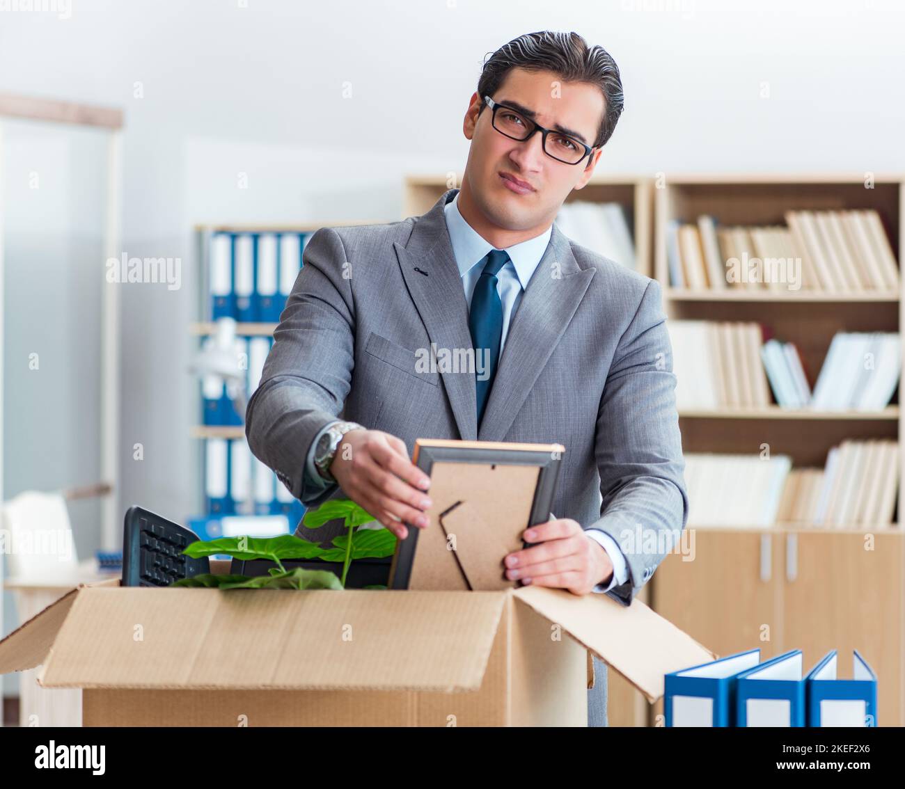 The man moving office with box and his belongings Stock Photo - Alamy