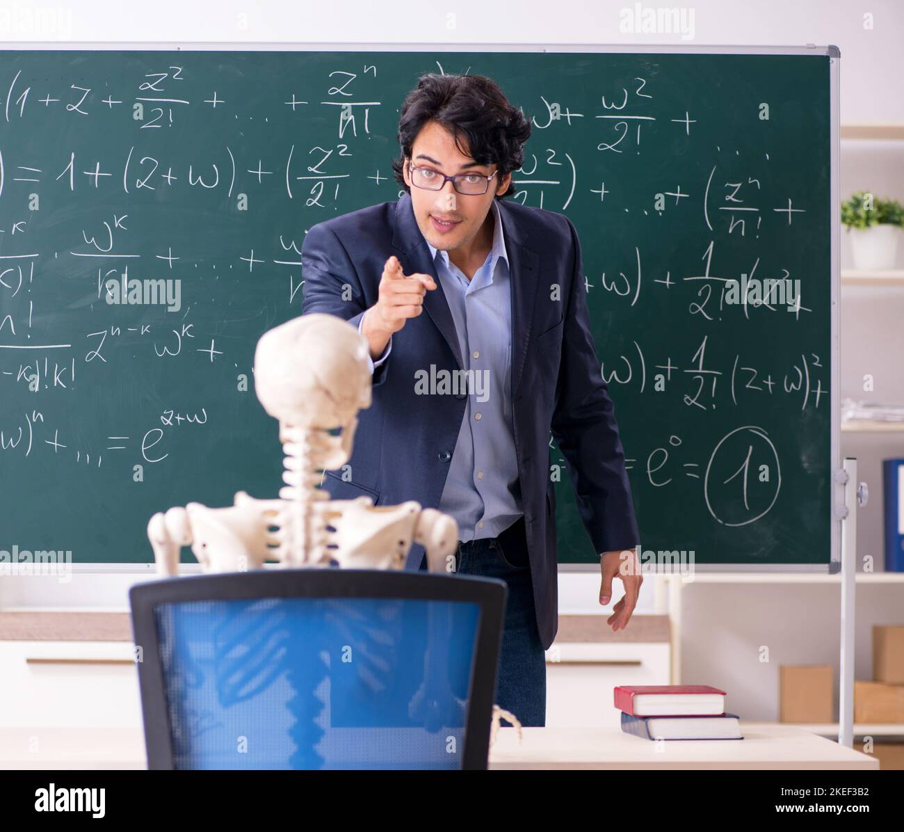 The young male math teacher and student skeleton Stock Photo - Alamy