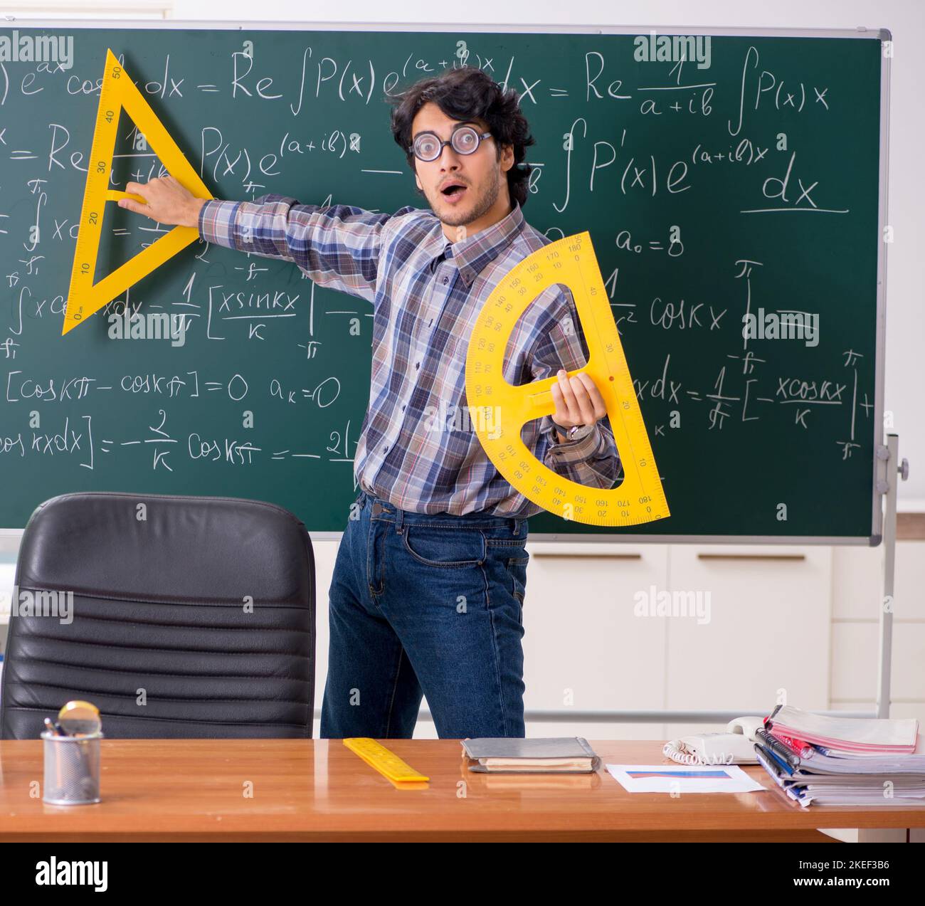 The funny male math teacher in the classroom Stock Photo - Alamy