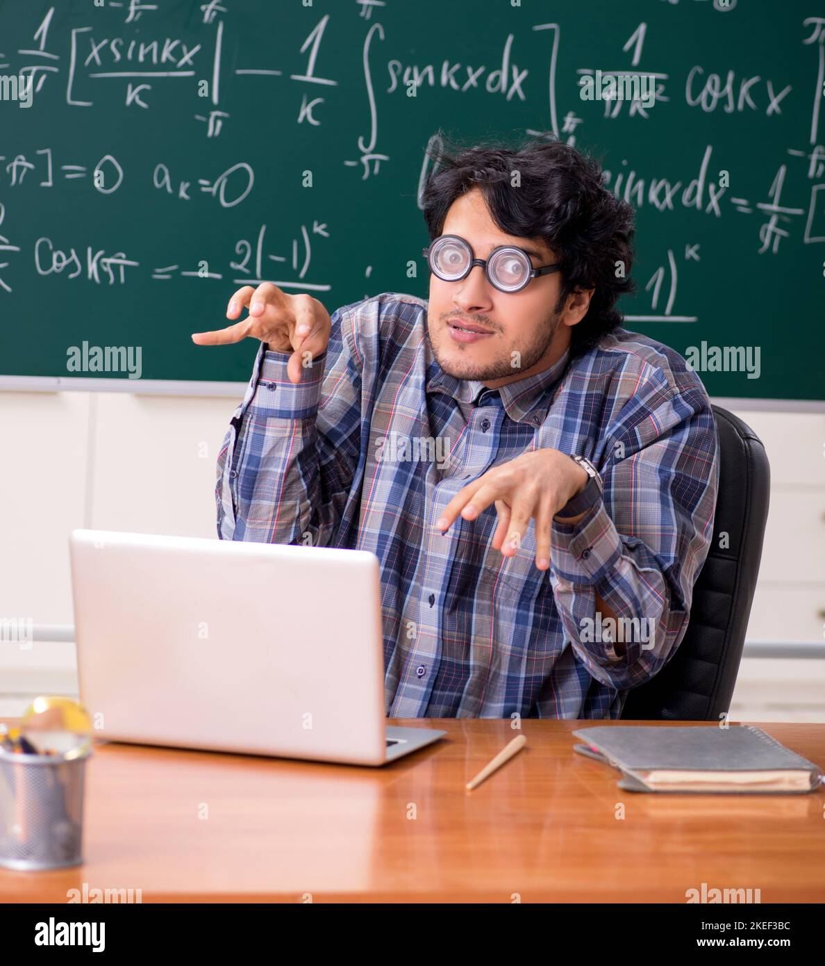 The funny male math teacher in the classroom Stock Photo - Alamy