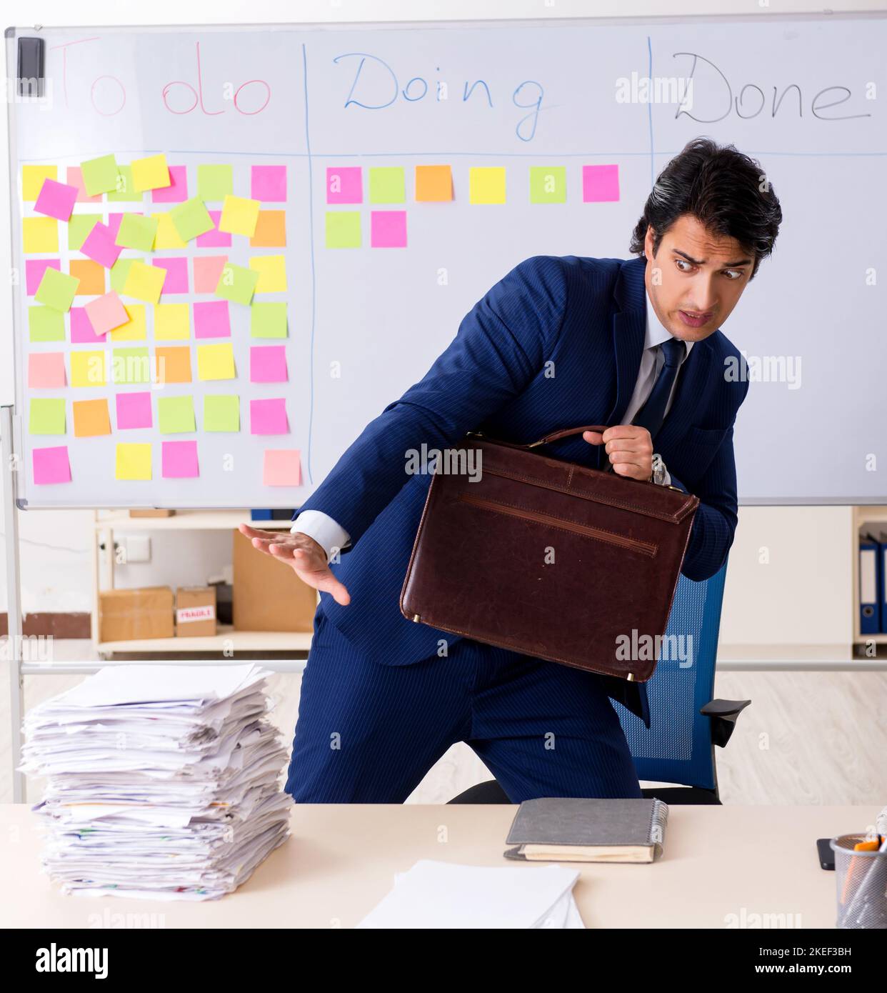 The young handsome employee in front of whiteboard with to-do list ...