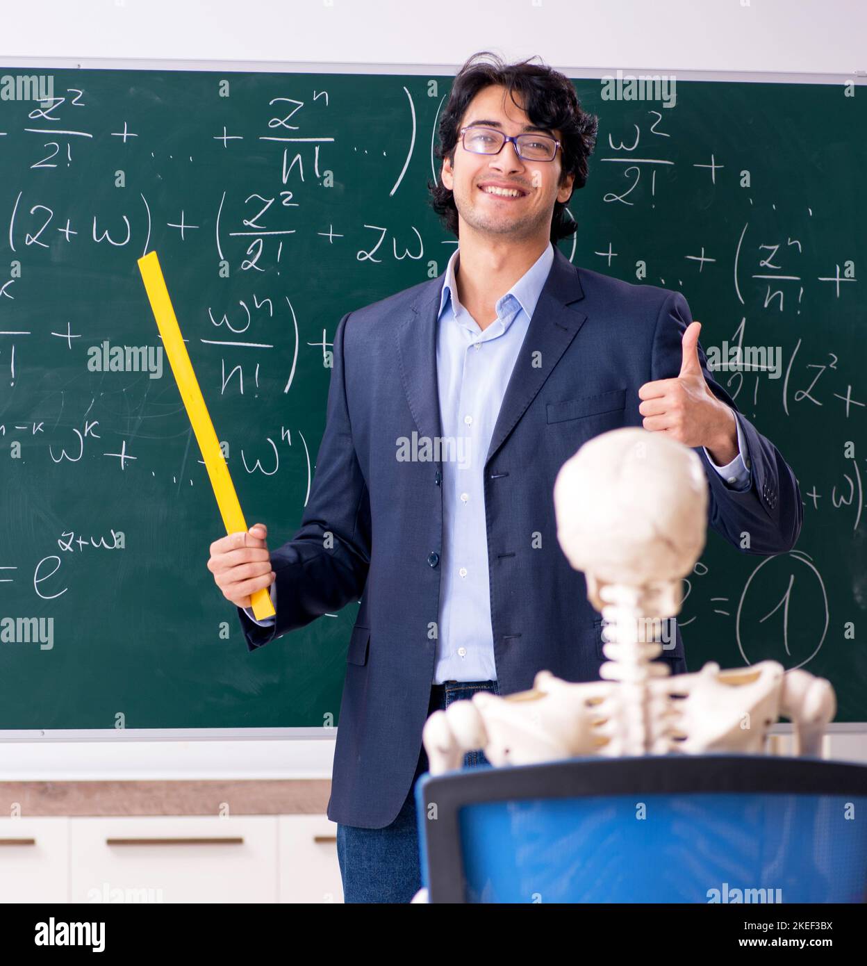 The young male math teacher and student skeleton Stock Photo - Alamy
