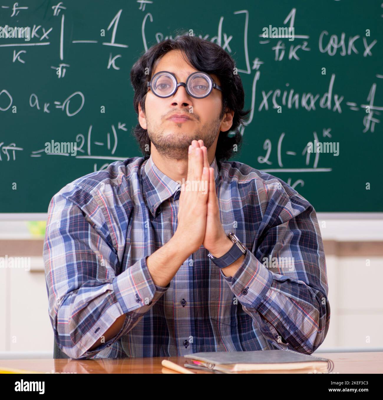 The funny male math teacher in the classroom Stock Photo - Alamy