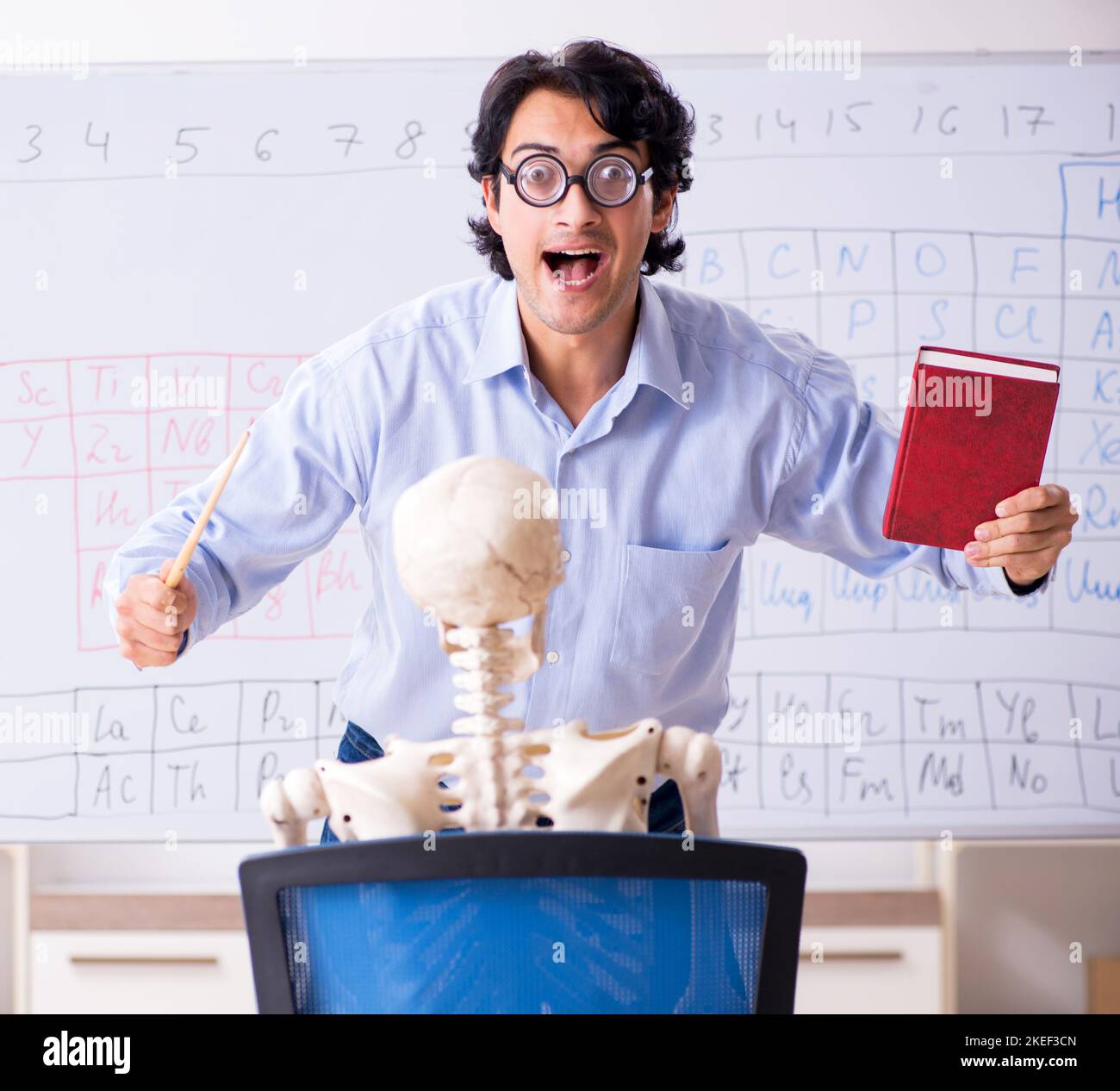 The young male chemist teacher and student skeleton Stock Photo - Alamy