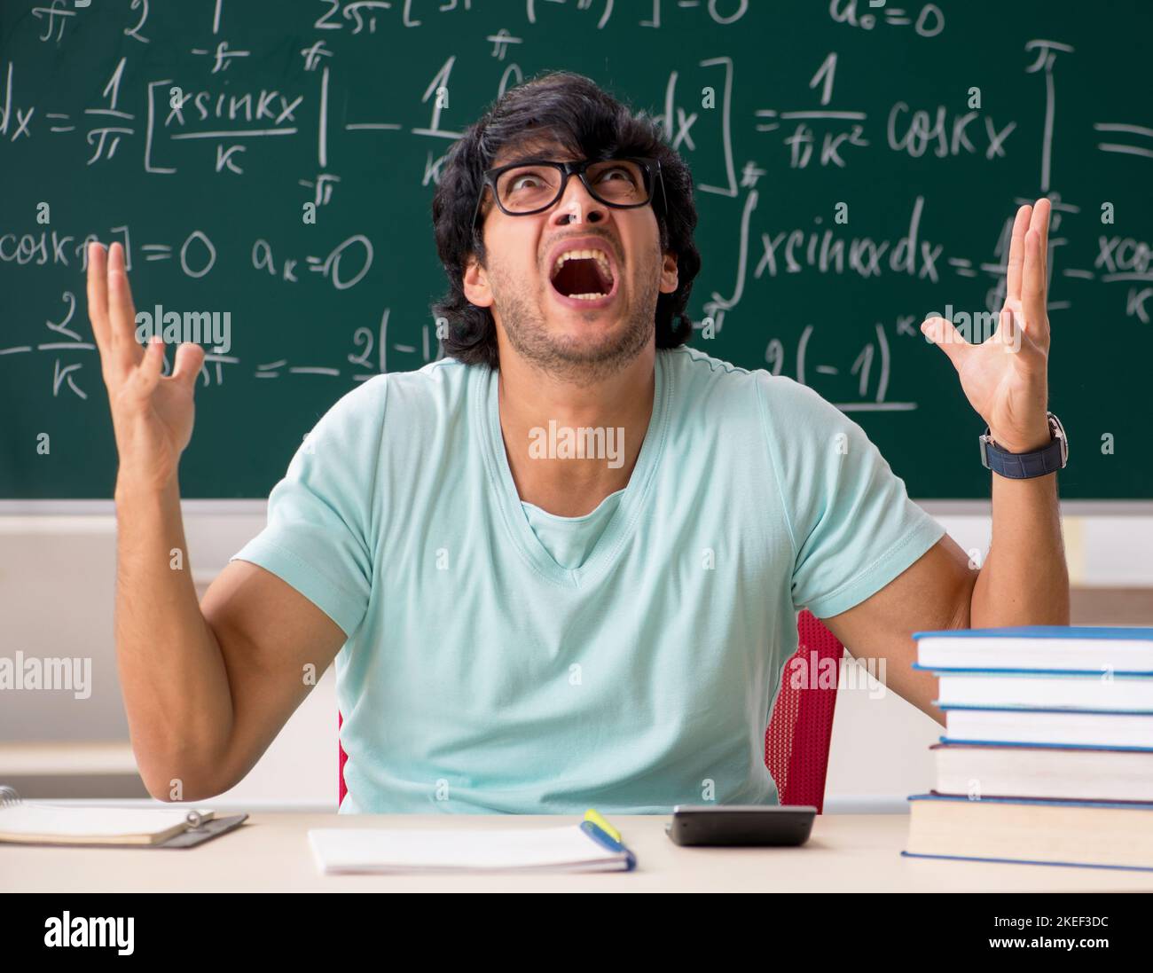 The young male student mathematician in front of chalkboard Stock Photo ...