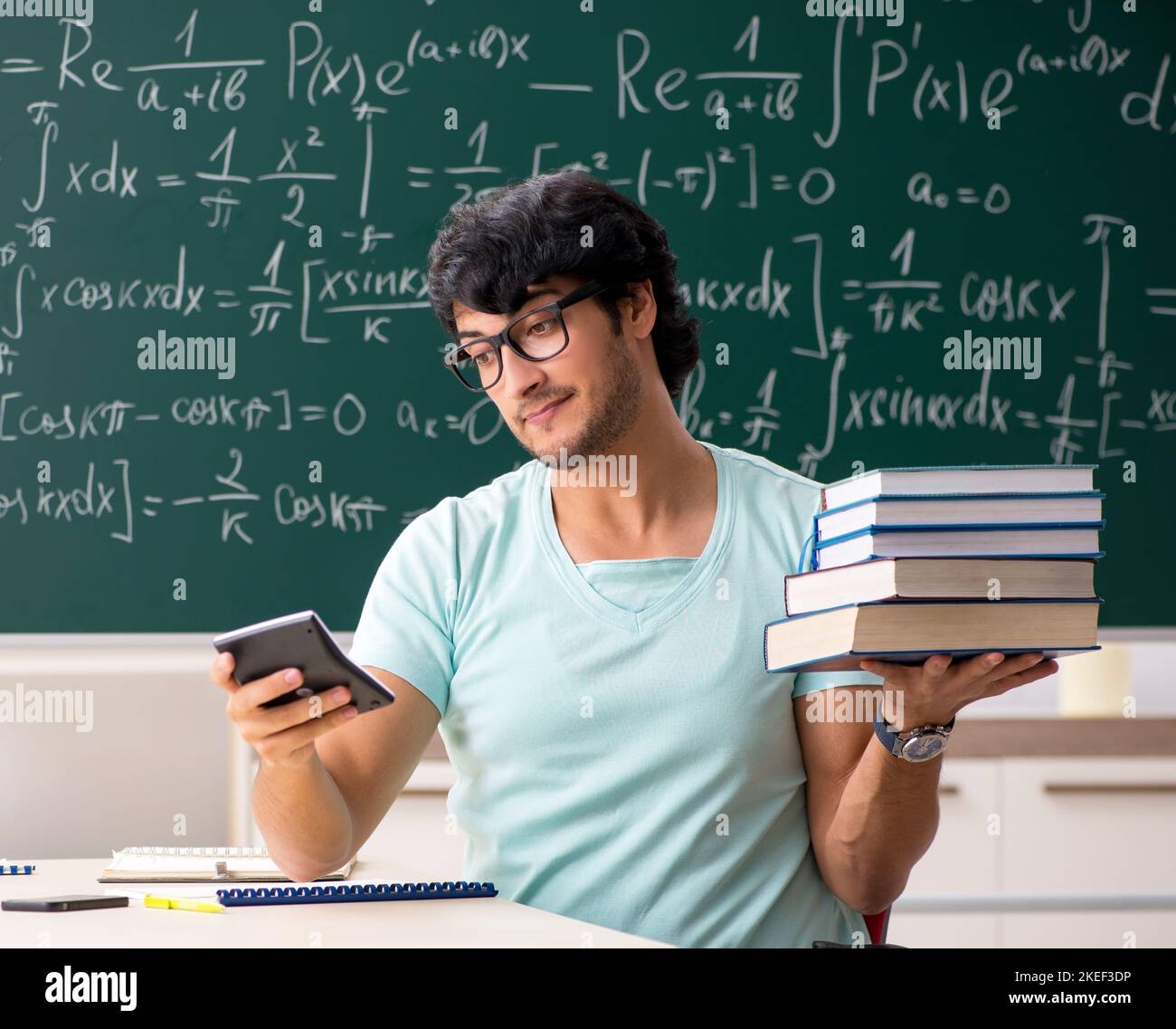 The young male student mathematician in front of chalkboard Stock Photo ...