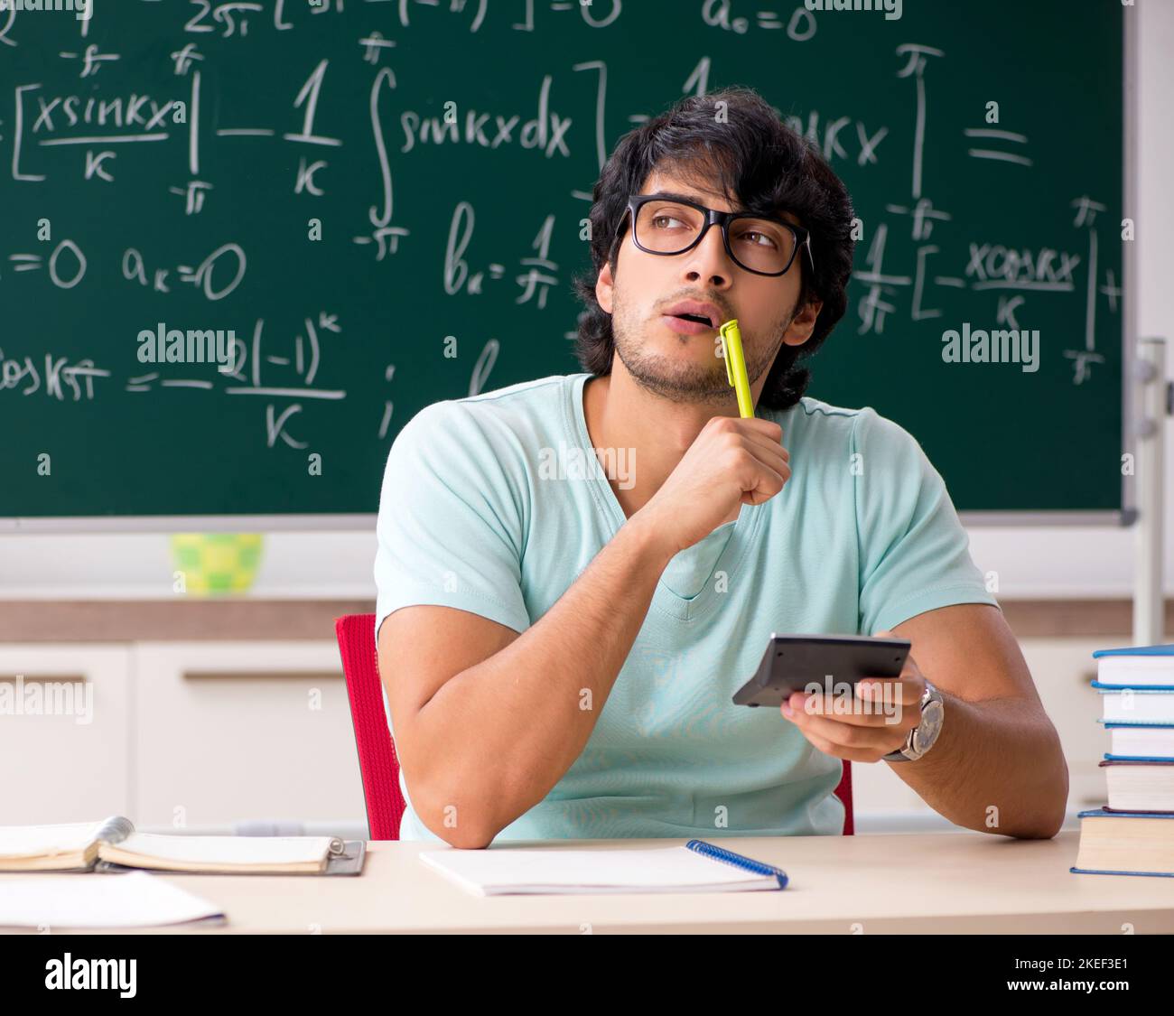 The young male student mathematician in front of chalkboard Stock Photo ...