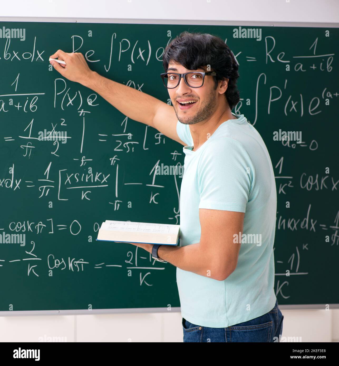 The young male student mathematician in front of chalkboard Stock Photo ...