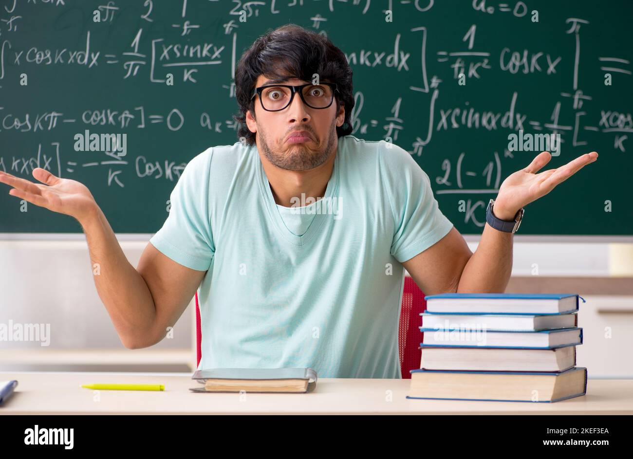 The young male student mathematician in front of chalkboard Stock Photo ...