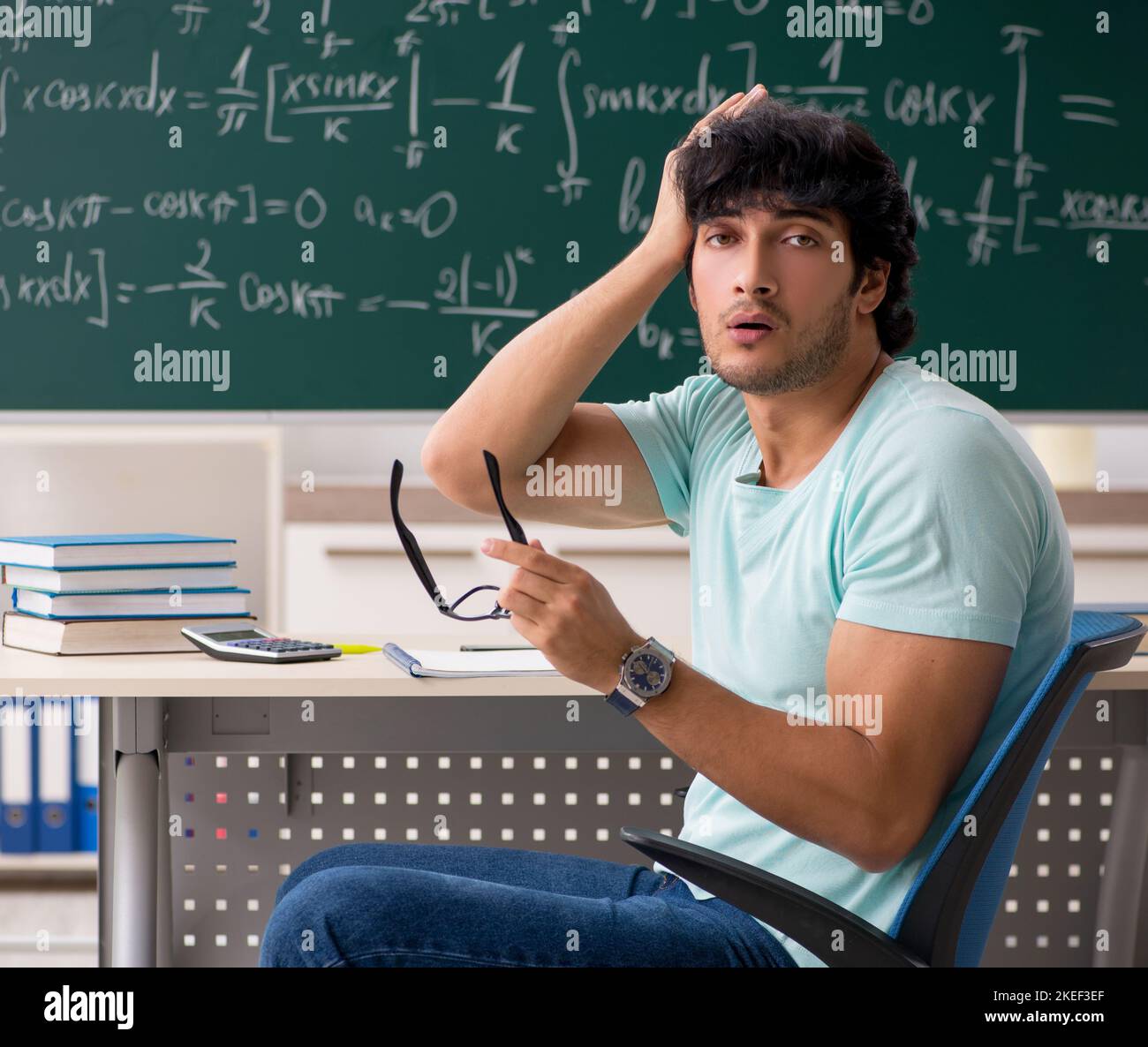 The young male student mathematician in front of chalkboard Stock Photo ...