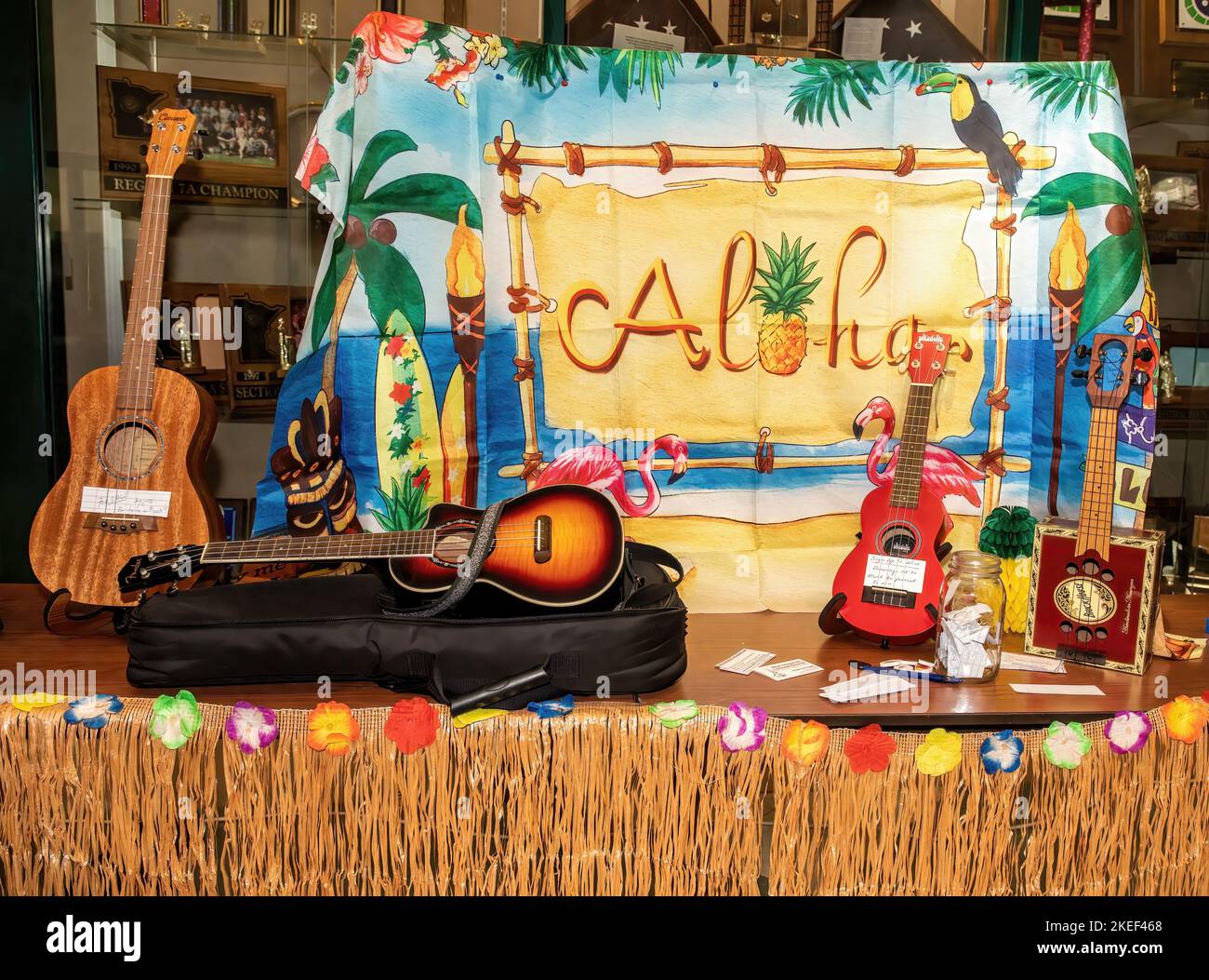 Colorful cloth with a Hawaiian scene with the word Aloha surrounded by ...