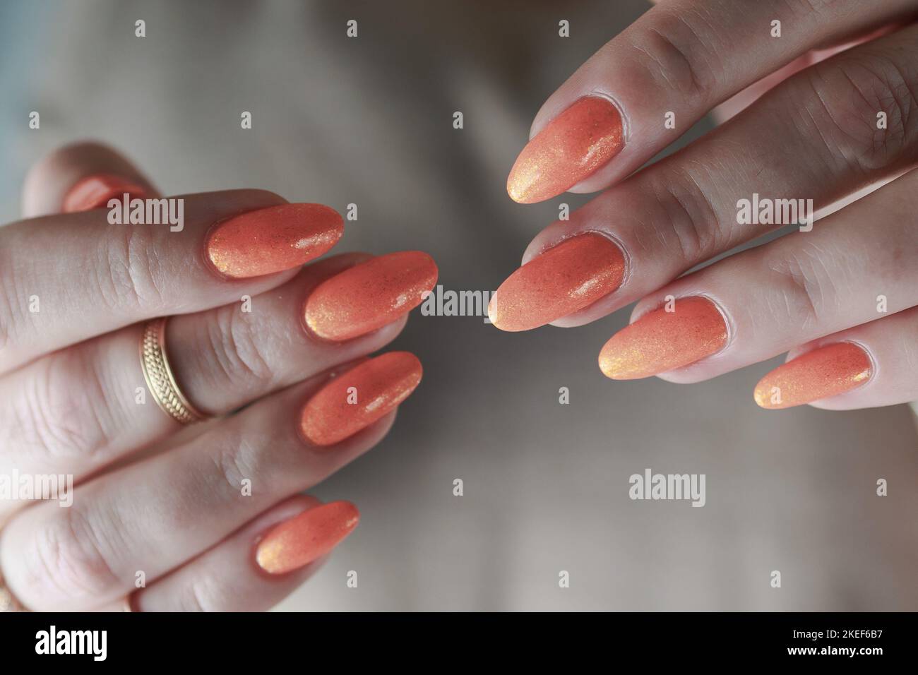 Female hand with long nails and a yellow orange nail polish Stock Photo ...