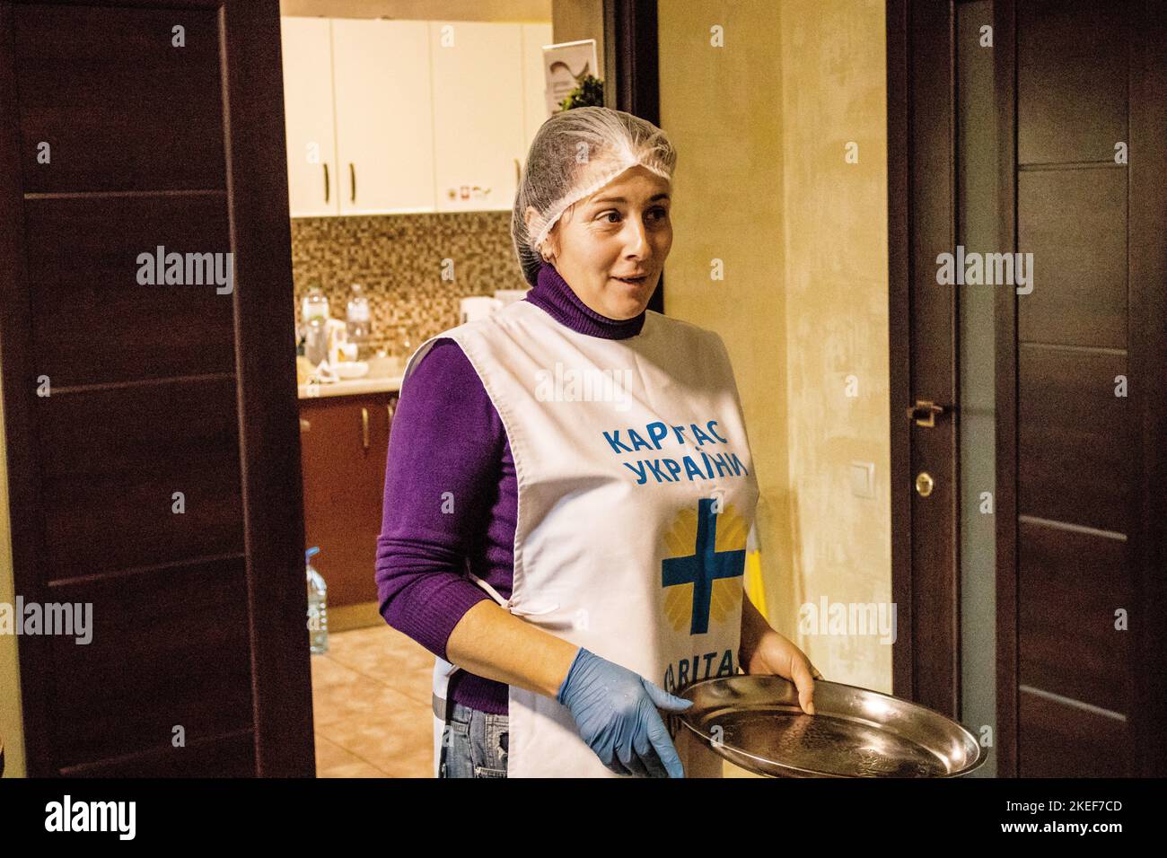 Volunteers working at the kitchen in Dnipro Caritas refugee center ...