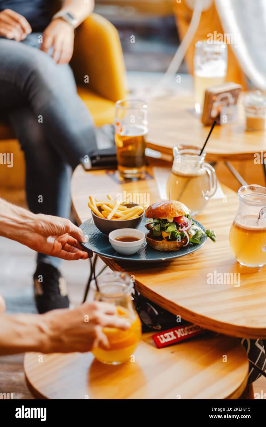 A vertical shot of a gourmet fast food restaurant table with burgers ...