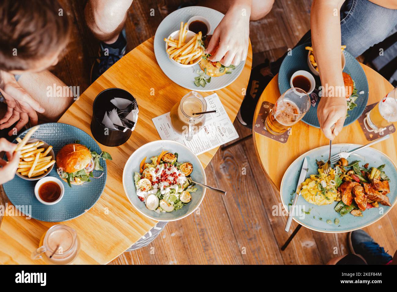 A top view of a group of friends eating food at a gourmet fast food ...