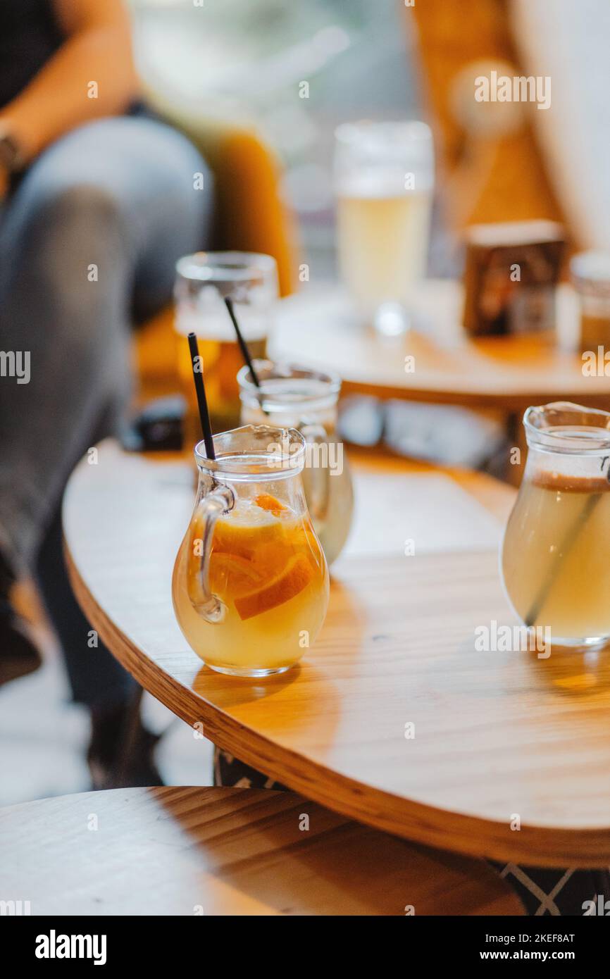 A vertical shot of fresh citrus fruit lemonades on a restaurant table ...