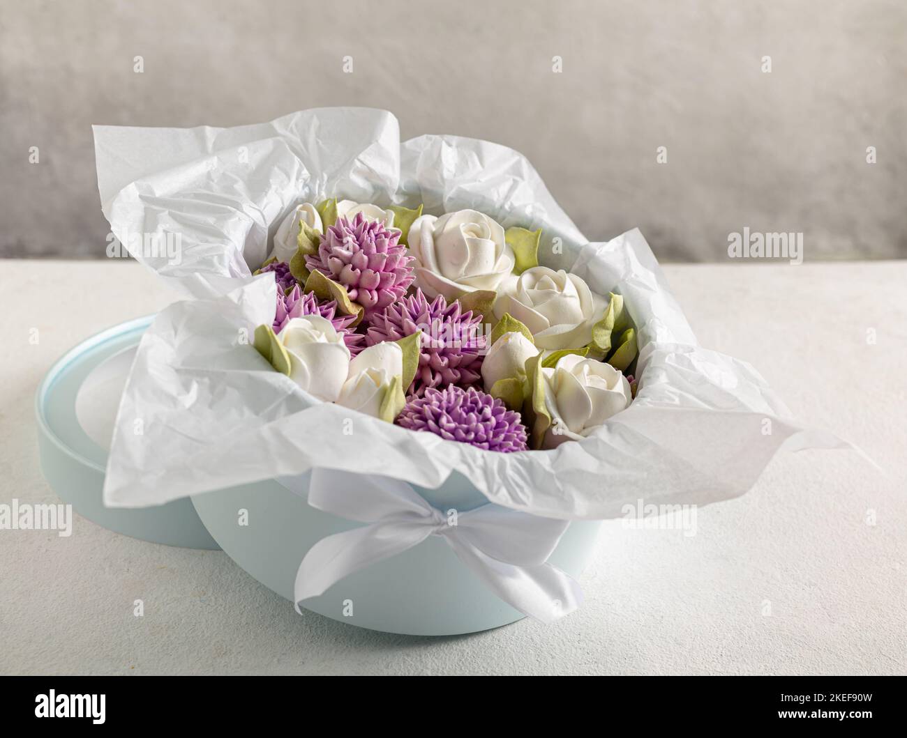 Zephyr bouquet of flowers in a gift box on a light background ...