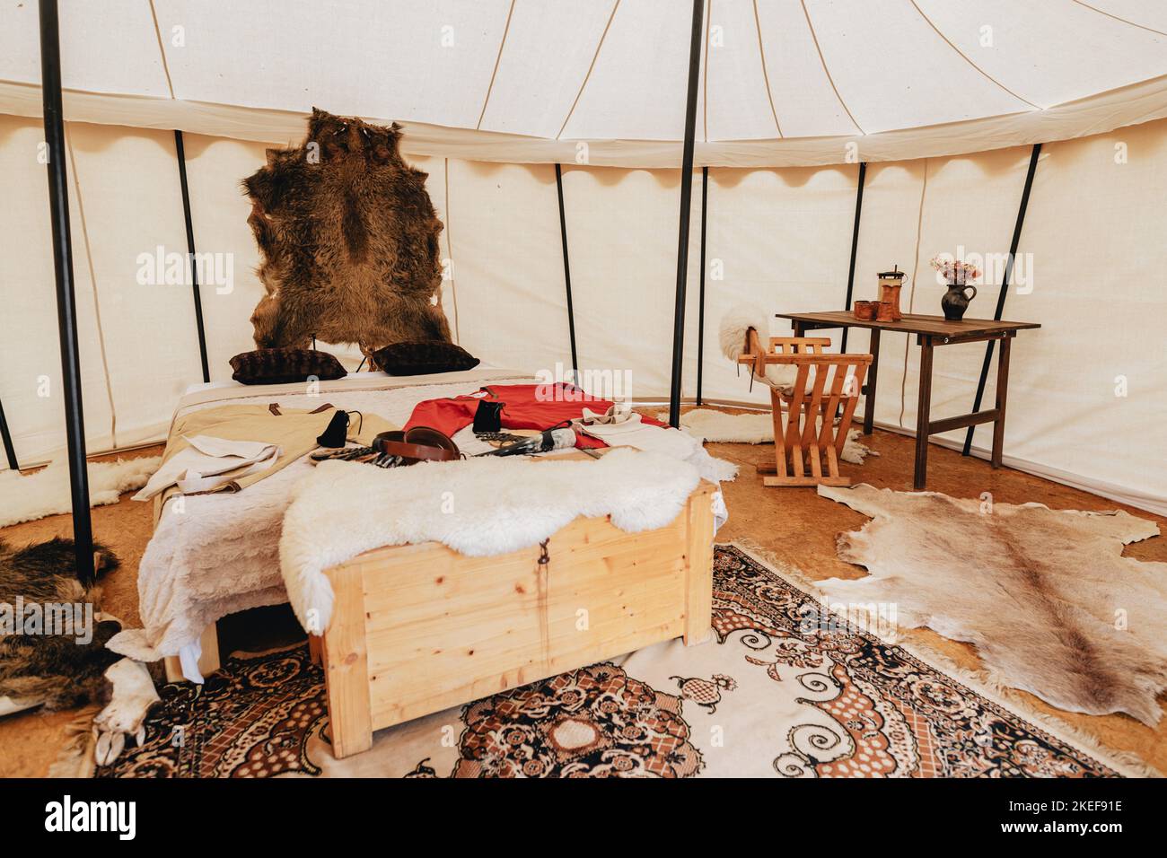 The interior of a rustic-style tent with hunting equipment and ...