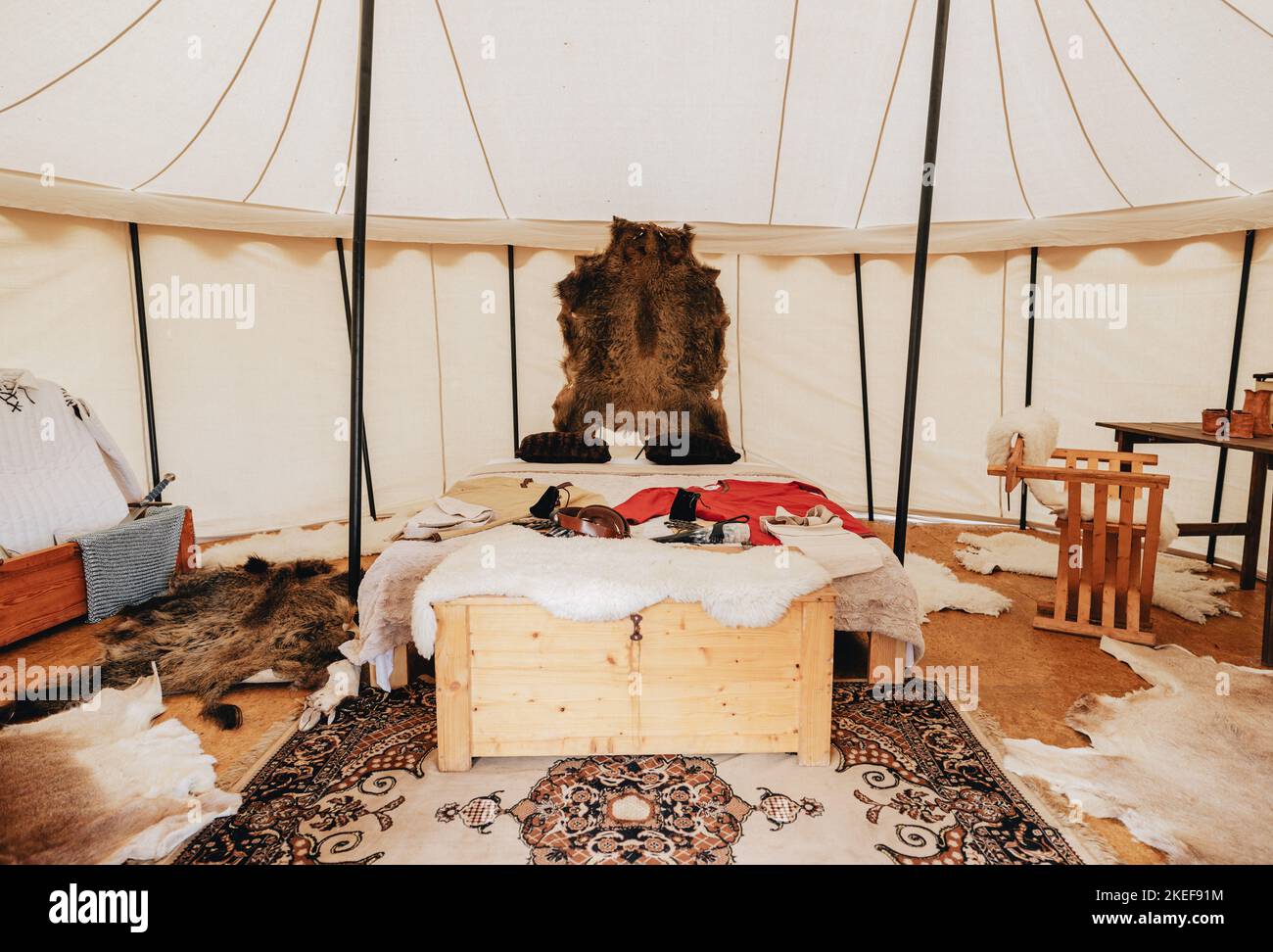 The interior of a rustic-style tent with hunting equipment and ...