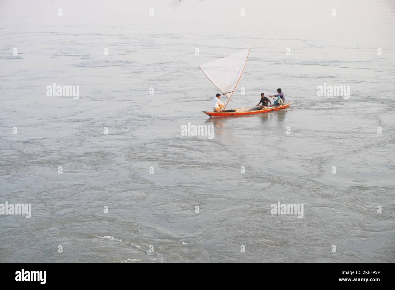 Small fishing boat sailing in river Stock Photo - Alamy