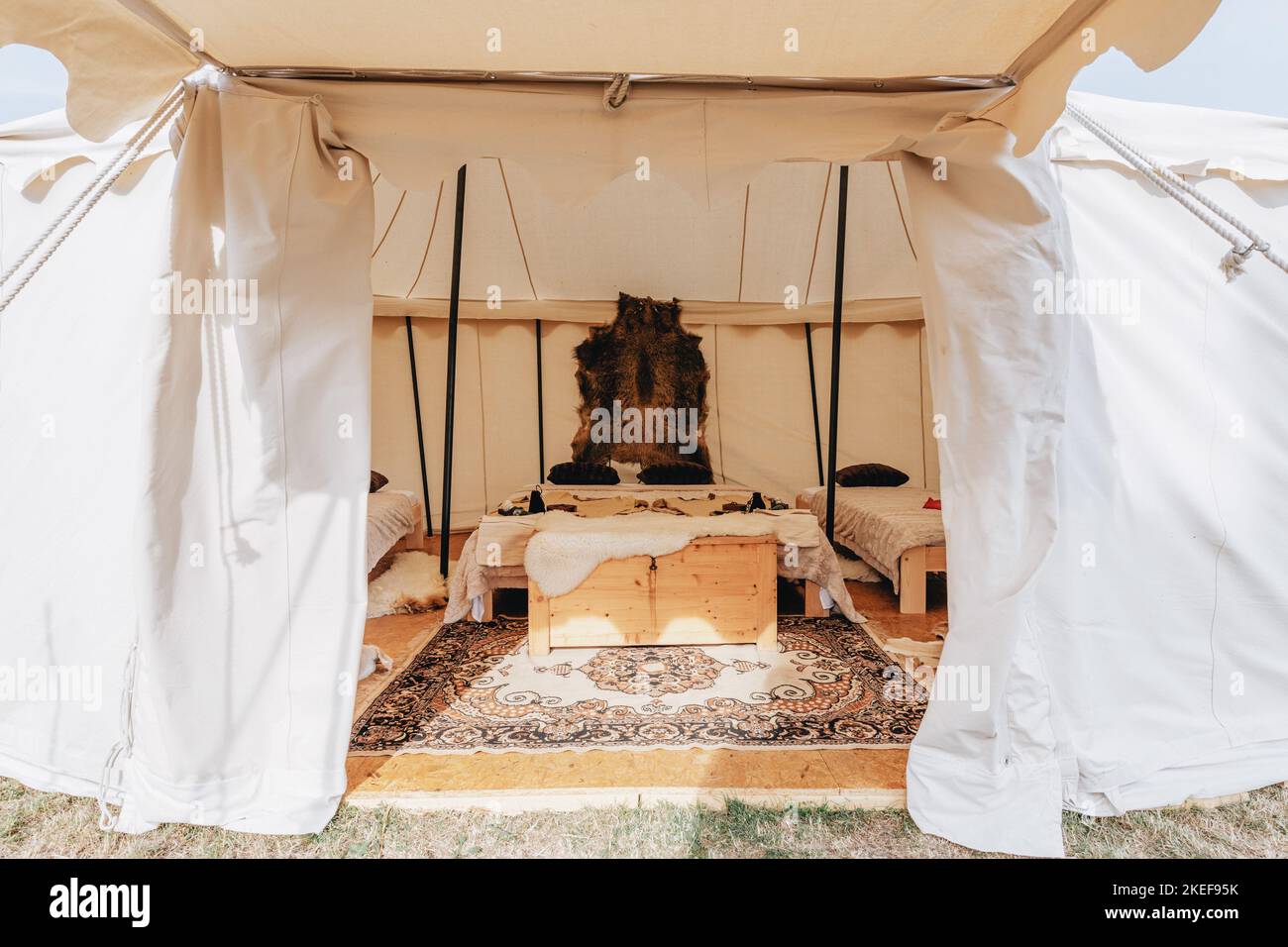 A beautiful shot of the interior of a rustic-style tent with beds for ...