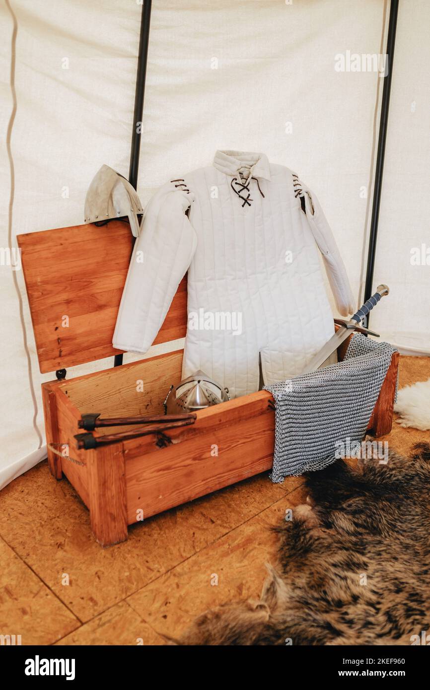 The interior of a rustic-style tent with hunting equipment and ...