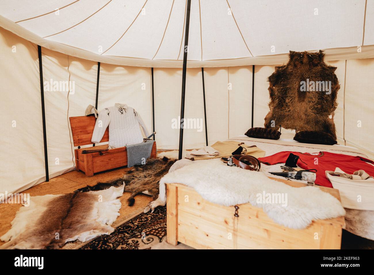 The interior of a rustic-style tent with hunting equipment and ...