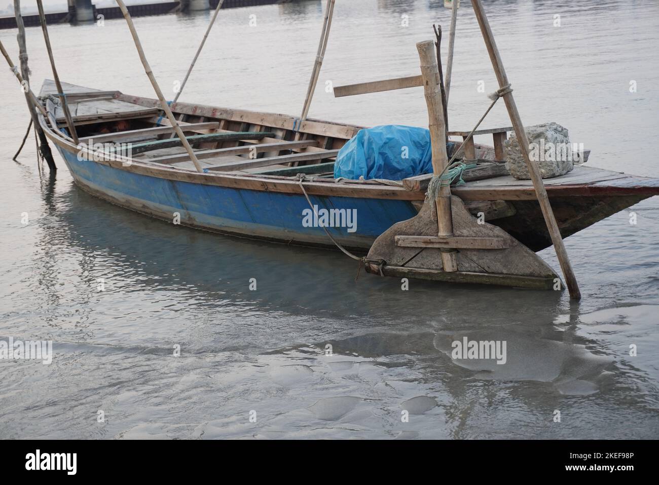 Small fishing boat sailing in river Stock Photo - Alamy