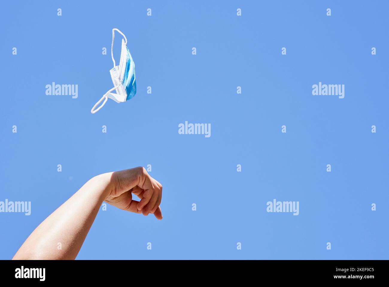 someone flying a kite in the air with their hand and fingers extended ...