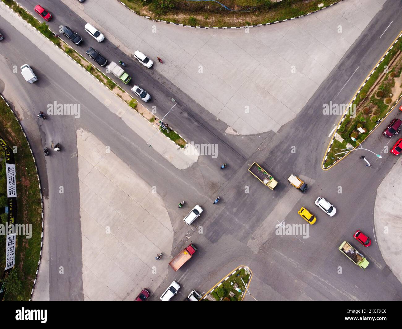 A high angle of cars on a high way road observing the traffic light ...