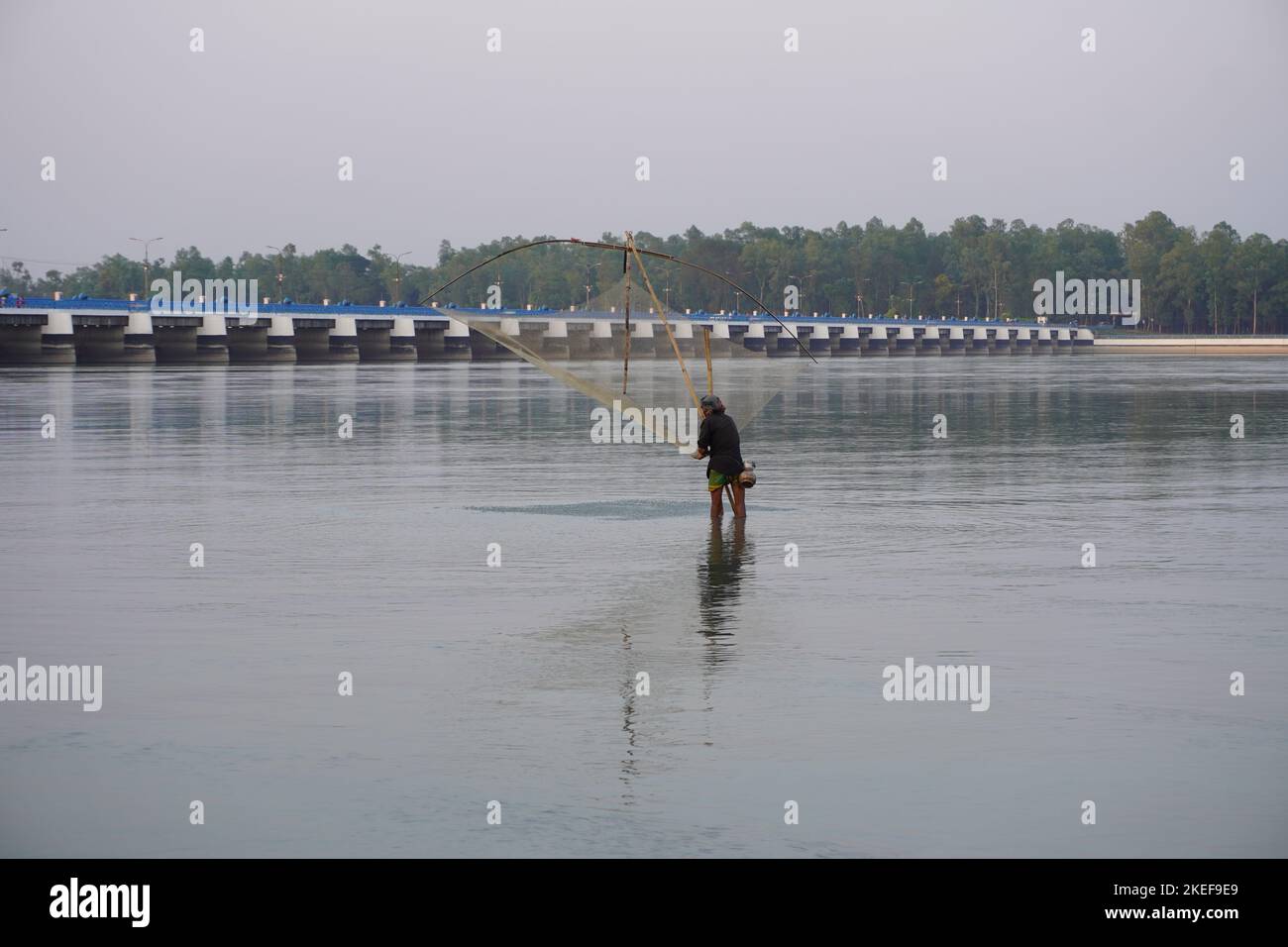 Man fishing in the river by net Stock Photo - Alamy