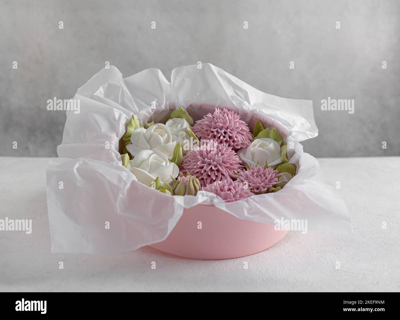 Zephyr bouquet of flowers in a gift box on a light background ...