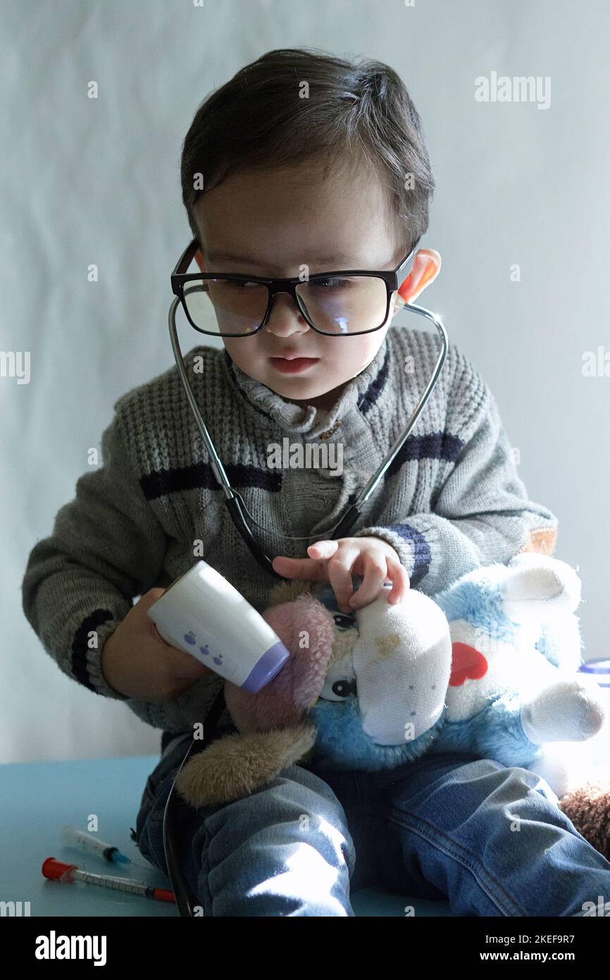 a little boy playing with his stuffed animals and drinking milk from a ...