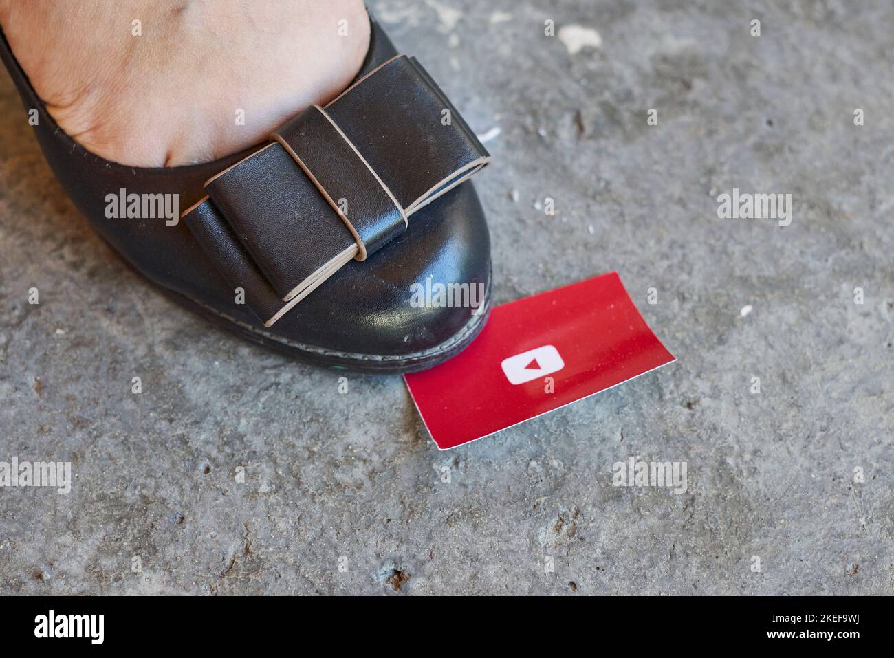someone's foot with a red card stuck to the bottom of their shoe, which ...