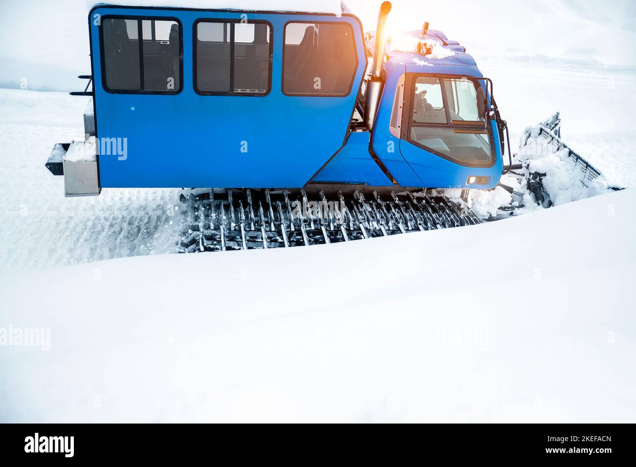 Rear back door window view blue modern snowcat ratrack grooming machine ...