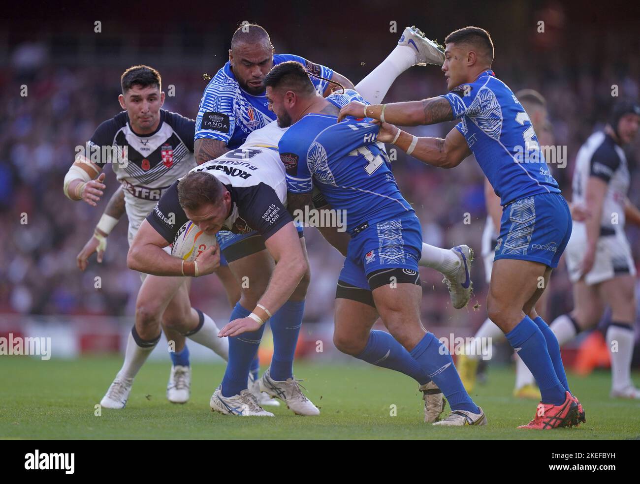 England's Thomas Burgess is tackled by Samoa's Junior Paulo during the ...