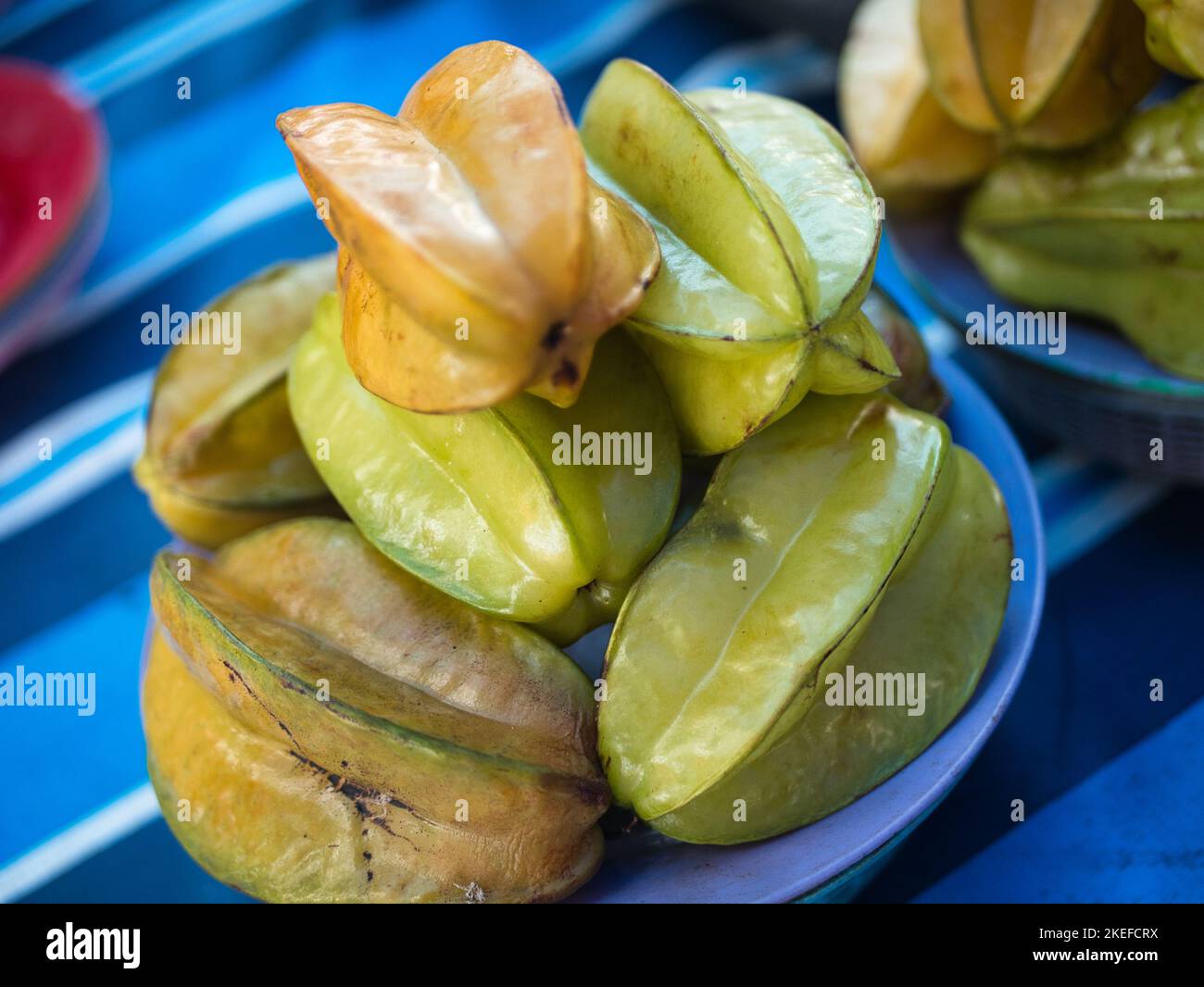 Star fruits also known as Averrhoa Carambola on a plate for sale at the ...