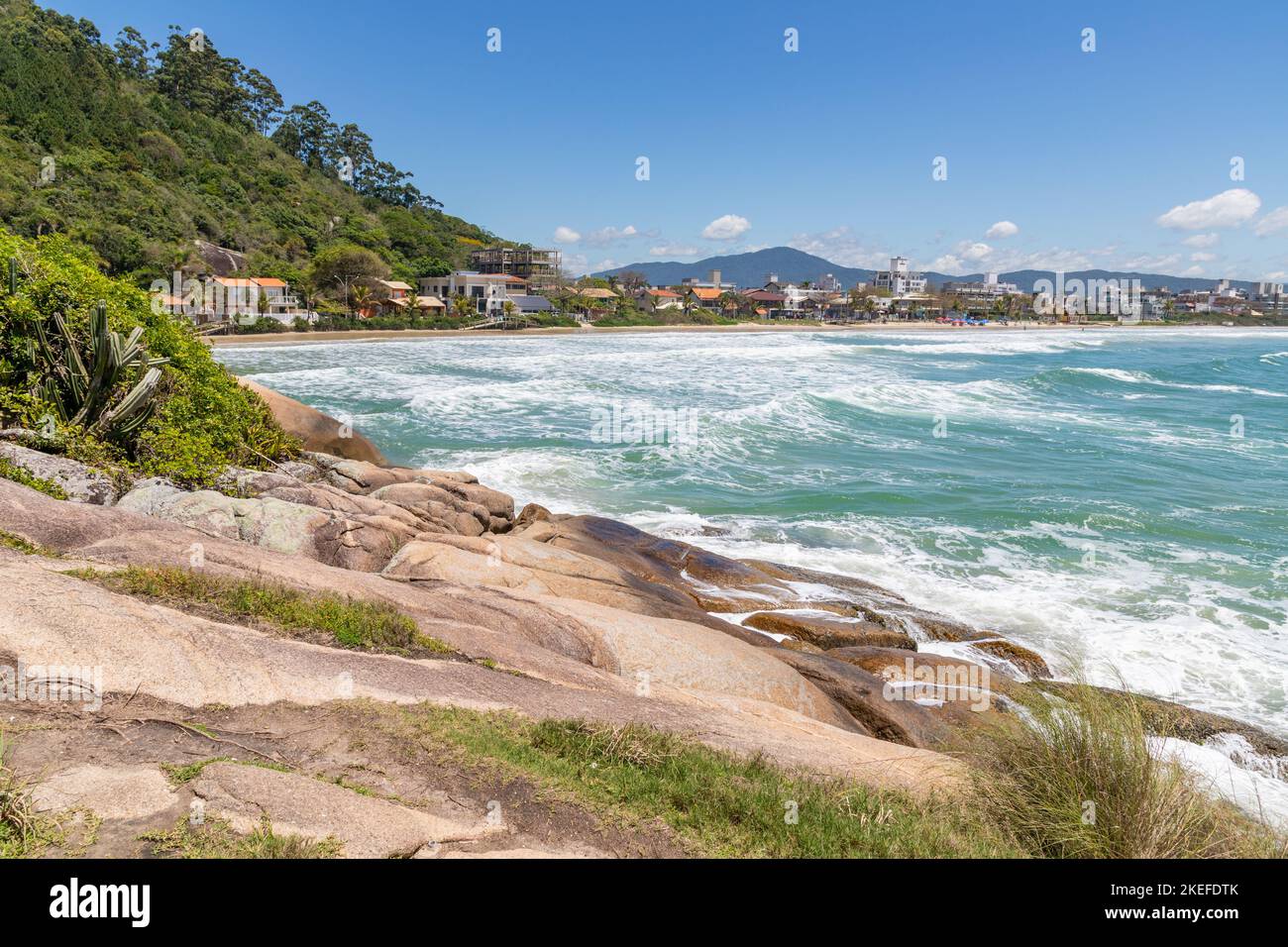 Beach viewwith rocks, forest, houses and mountain in Canto Grande beach ...