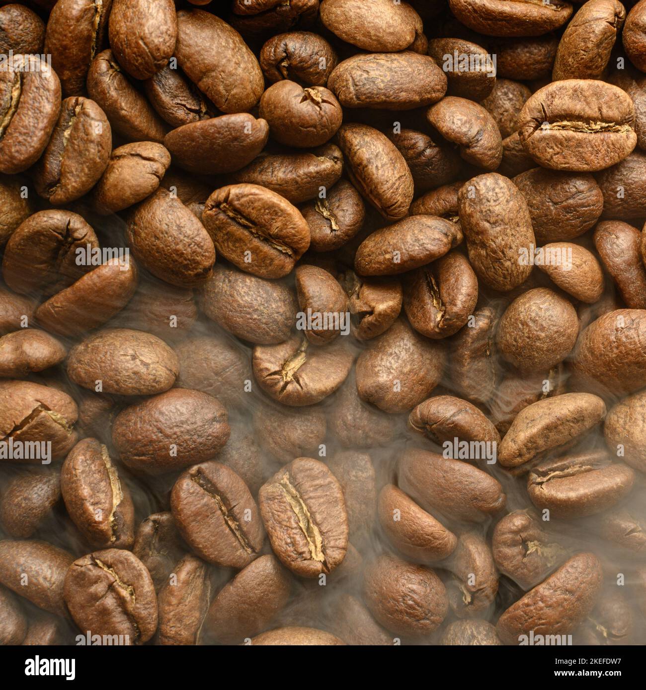 Texture of freshly roasted ready-to-drink coffee, steam rising above ...