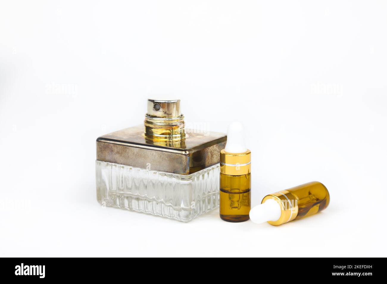 Unbranded perfume spray bottle and two bottles of hyaluronic acid with ...