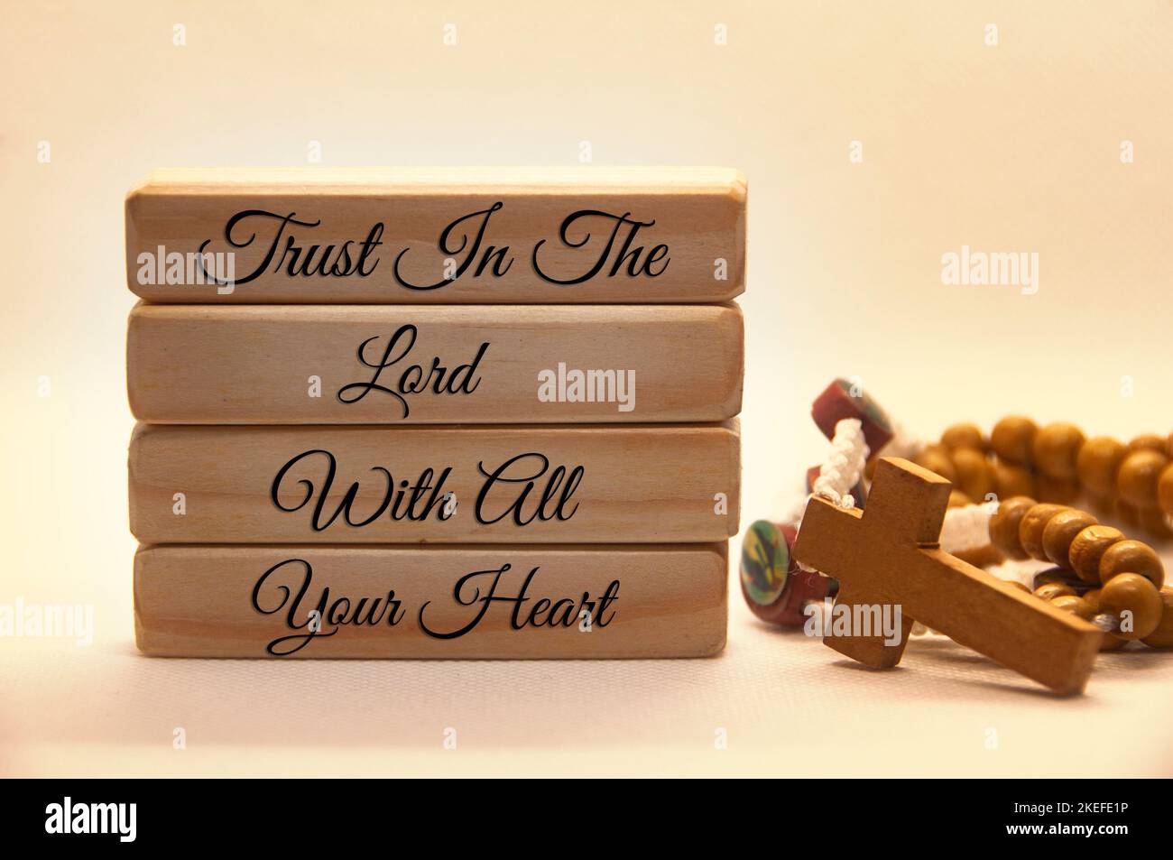 Trusting God message text on wooden blocks with Holy Rosary background ...