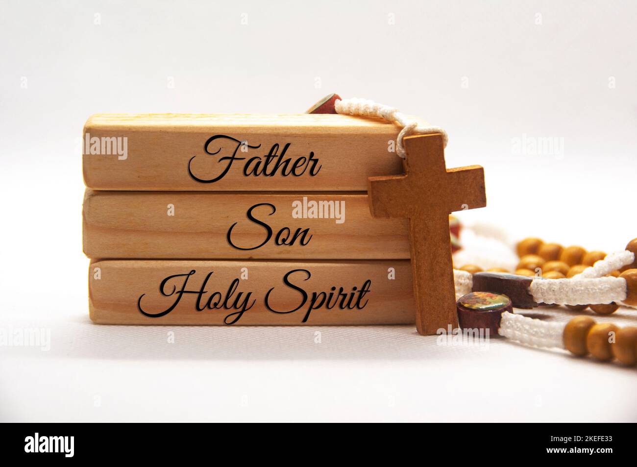 Father, So and Holy Spirit text on wooden blocks with Holy Rosary ...