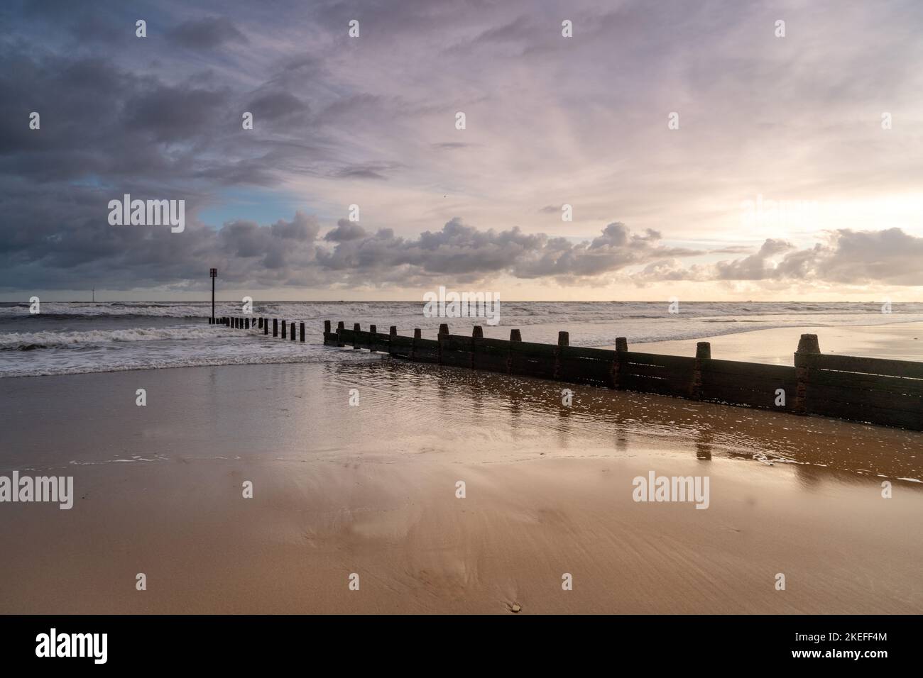 A scenic view of a beautiful seascape with wooden groins on the shore ...