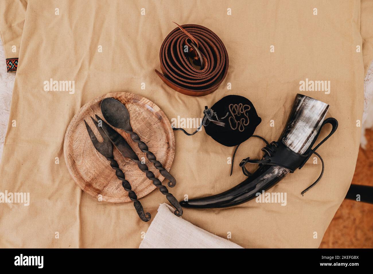 A closeup shot of a traditional robe and hunting weapons and equipment ...