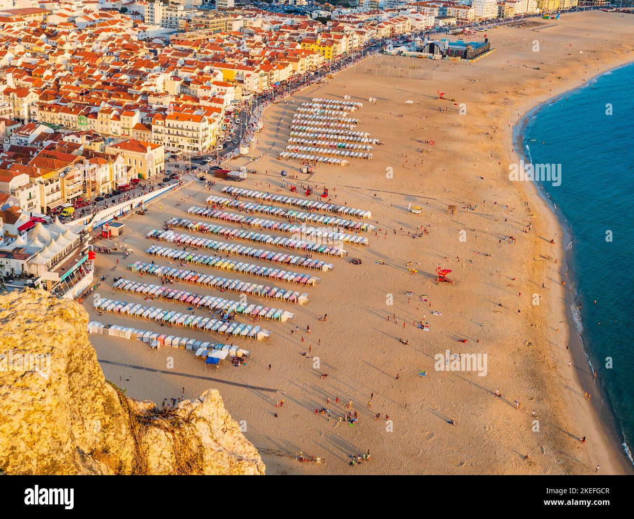Panoramic view of Nazare beach (praia de Nazare) with colorful bathing ...