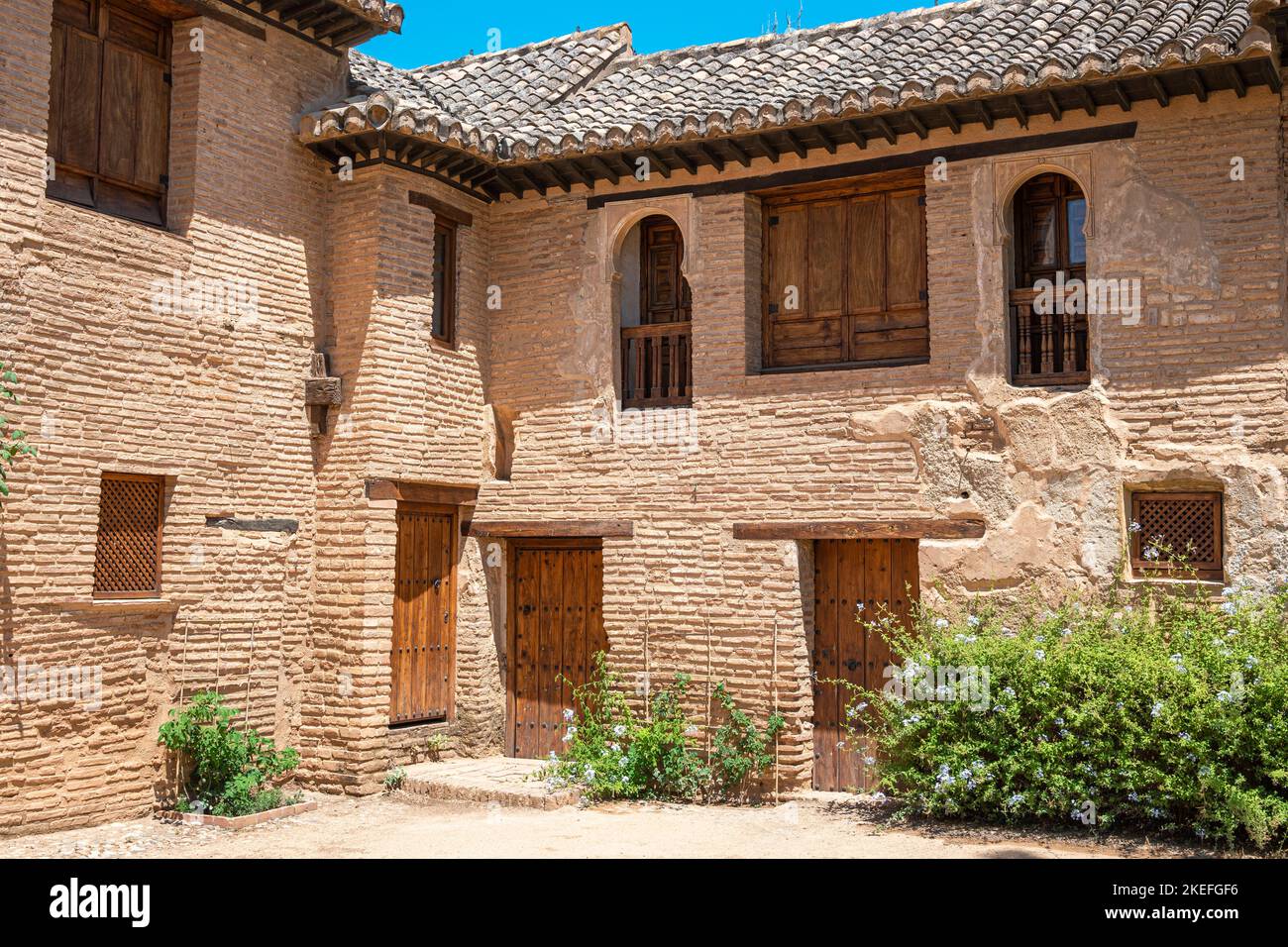 A beautiful shot of the historic Alhambra palace and palm trees in ...